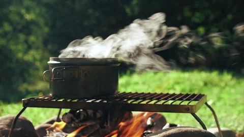 Close-up of cauldron with water over bur... | Stock Video | Pond5