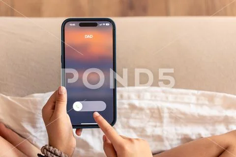Photograph: Close up of child hands holding phone with Dad's incoming ...