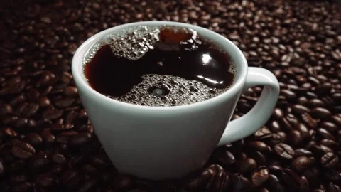 Close up of coffee bean drop in to hot e... | Stock Video | Pond5