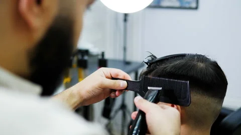 A close-up of a comb and a trimmer in th... | Stock Video | Pond5
