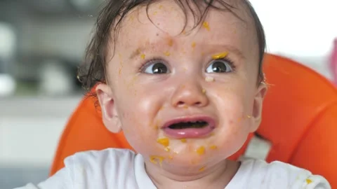 Close-up of a crying baby at a table for... | Stock Video | Pond5