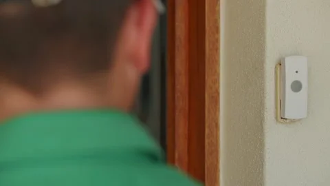 Close Up Of Delivery Man Pushing Doorbel... | Stock Video | Pond5