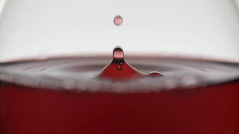 Close up of a drop falling in glass with... | Stock Video | Pond5