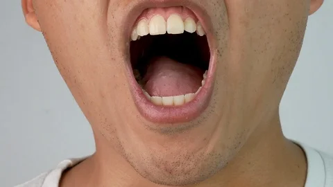 Close-up face of a sleepy and yawned you... | Stock Video | Pond5