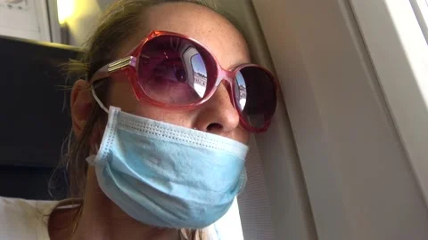 Close up face of woman in mask on plane ... | Stock Video | Pond5