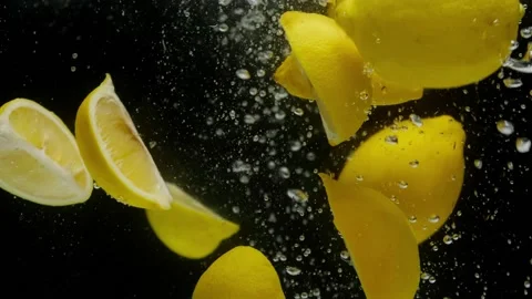 Close-up of falling sliced lemons into t... | Stock Video | Pond5