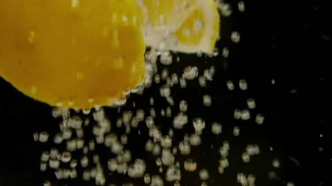 Close-up of falling sliced lemons into t... | Stock Video | Pond5