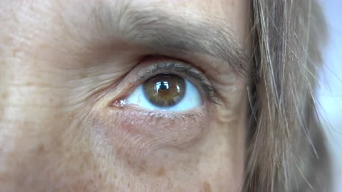 Close up a female eye with window reflec... | Stock Video | Pond5