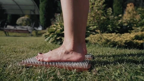 Close up to female feet step on Nail boa... | Stock Video | Pond5