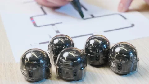 Close up of a five ozobot, man draw the ... | Stock Video | Pond5