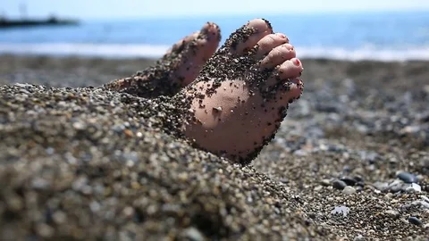 Close-up, the girl's feet buried in the ... | Stock Video | Pond5