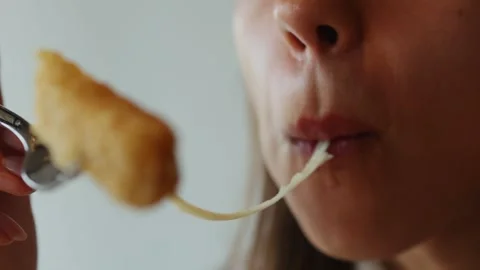 A close-up of a girl's mouth biting a ch... | Stock Video | Pond5