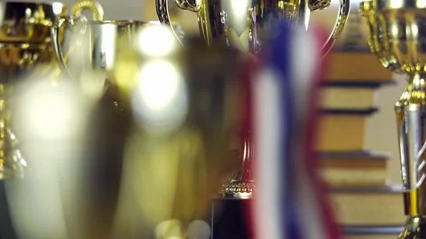 close up golden trophy and stack of boo... | Stock Video | Pond5