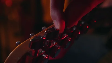 Close up of Hand Adjust the Peg of Elect... | Stock Video | Pond5