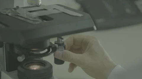 A close-up of a hand adjusting microscop... | Stock Video | Pond5