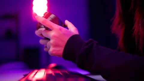 Close-up hand gamer with controller on k... | Stock Video | Pond5