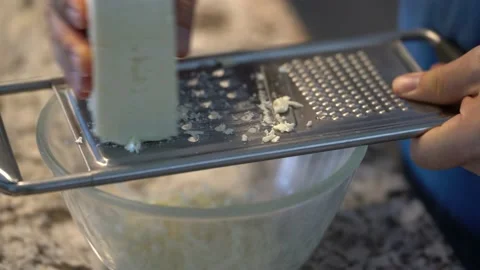 Close up of hand grating block of feta o... | Stock Video | Pond5