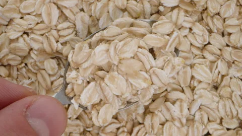 Close-up of a hand lifting a spoon with ... | Stock Video | Pond5