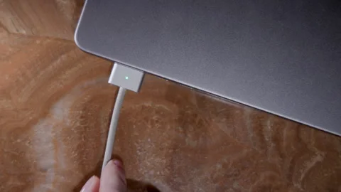 Close-up of a hand plugging cable in pow... | Stock Video | Pond5