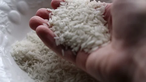 Close Up of Hand Pouring Rice into Bowl ... | Stock Video | Pond5