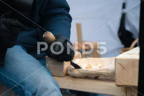 Photograph: Close up of hands of craftsman carve with a gouge in the ...