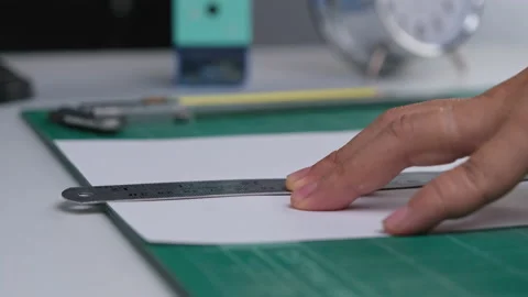 Close-up hands of female cutting paper u... | Stock Video | Pond5