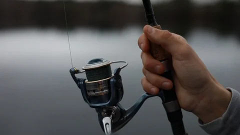 Close up of hands reeling in a fish with... | Stock Video | Pond5