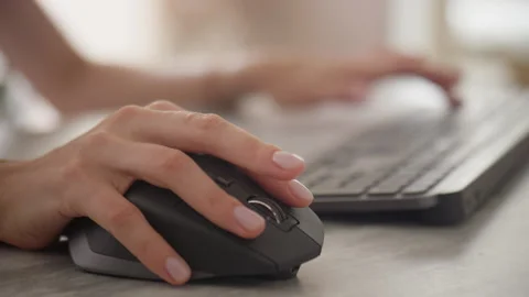 Close-up of hands using a mouse and typi... | Stock Video | Pond5