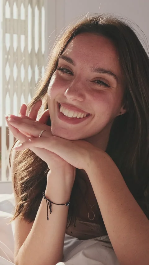 Close-up, happy girl posing lying in bed | Stock Video | Pond5