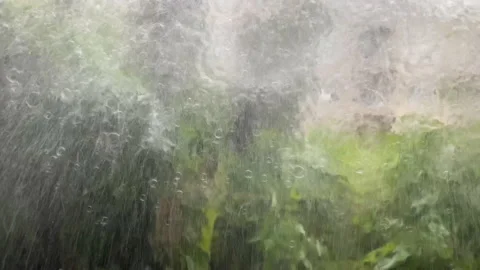 Close up of heavy rain falling on glass,... | Stock Video | Pond5
