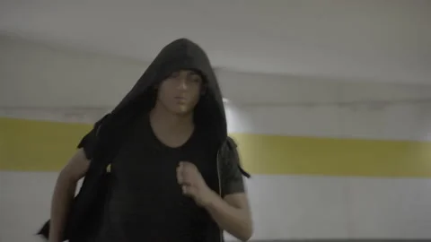 Close-Up Of A Hooded Young Man Running I... | Stock Video | Pond5