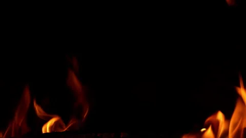 Close-up hot orange fire on black backgr... | Stock Video | Pond5