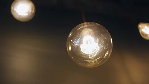 Close-up of a light bulb hanging on a wi... | Stock Video | Pond5