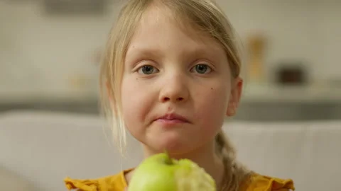 Close up little girl bite apple fruit ch... | Stock Video | Pond5