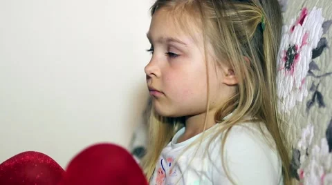 Close-up of little girl watching TV | Stock Video | Pond5