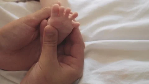 Close up of loving young dad massages ba... | Stock Video | Pond5