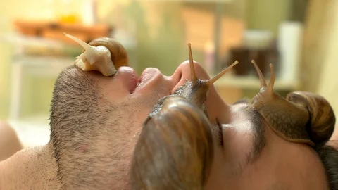 Close up male face covered with big snai... | Stock Video | Pond5