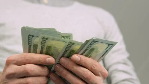 Close-up of male hands counting a stack ... | Stock Video | Pond5