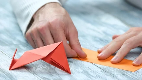 Close up man folding origami figure. | Stock Video | Pond5