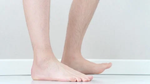 Close-up of men's feet barefoot on a til... | Stock Video | Pond5