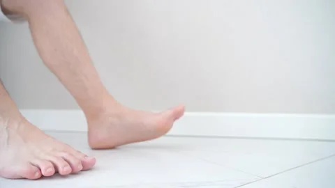 Close-up of men's feet barefoot on a til... | Stock Video | Pond5