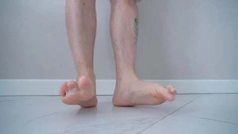 Close-up of men's feet barefoot on a til... | Stock Video | Pond5