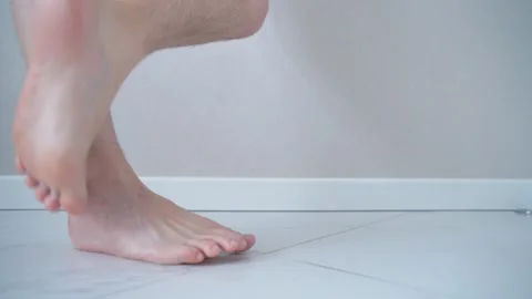 Close-up of men's feet barefoot on a til... | Stock Video | Pond5