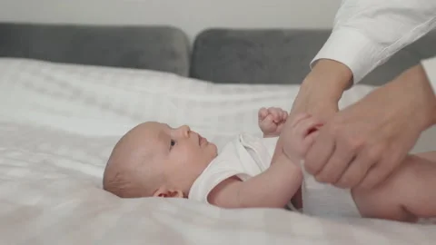 Close up of mother changing diaper to he... | Stock Video | Pond5
