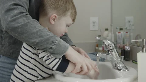 Close up of mother helping son washing h... | Stock Video | Pond5