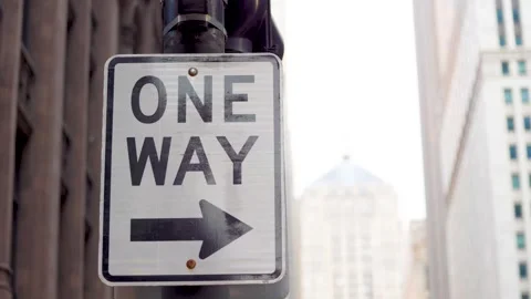 Close up of a one way sign in the downto... | Stock Video | Pond5