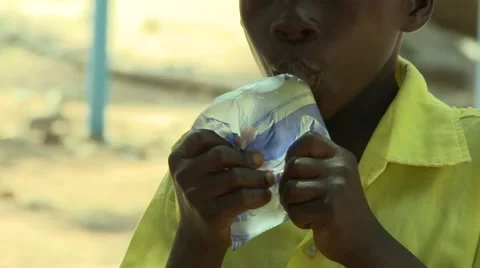 CLOSE UP: PAKRO BOY STUDENT DRINKS SACHE... | Stock Video | Pond5