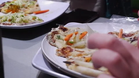 Close-up: People enjoy eating tasty pupu... | Stock Video | Pond5