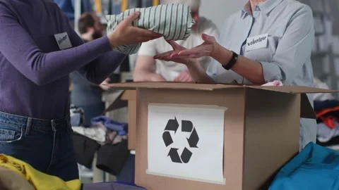 Close up of people pack clothes in cardb... | Stock Video | Pond5