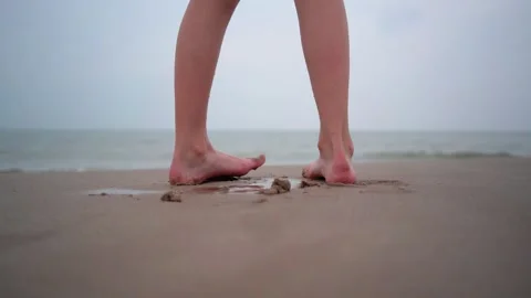 Close up of person bare feet walking at ... | Stock Video | Pond5
